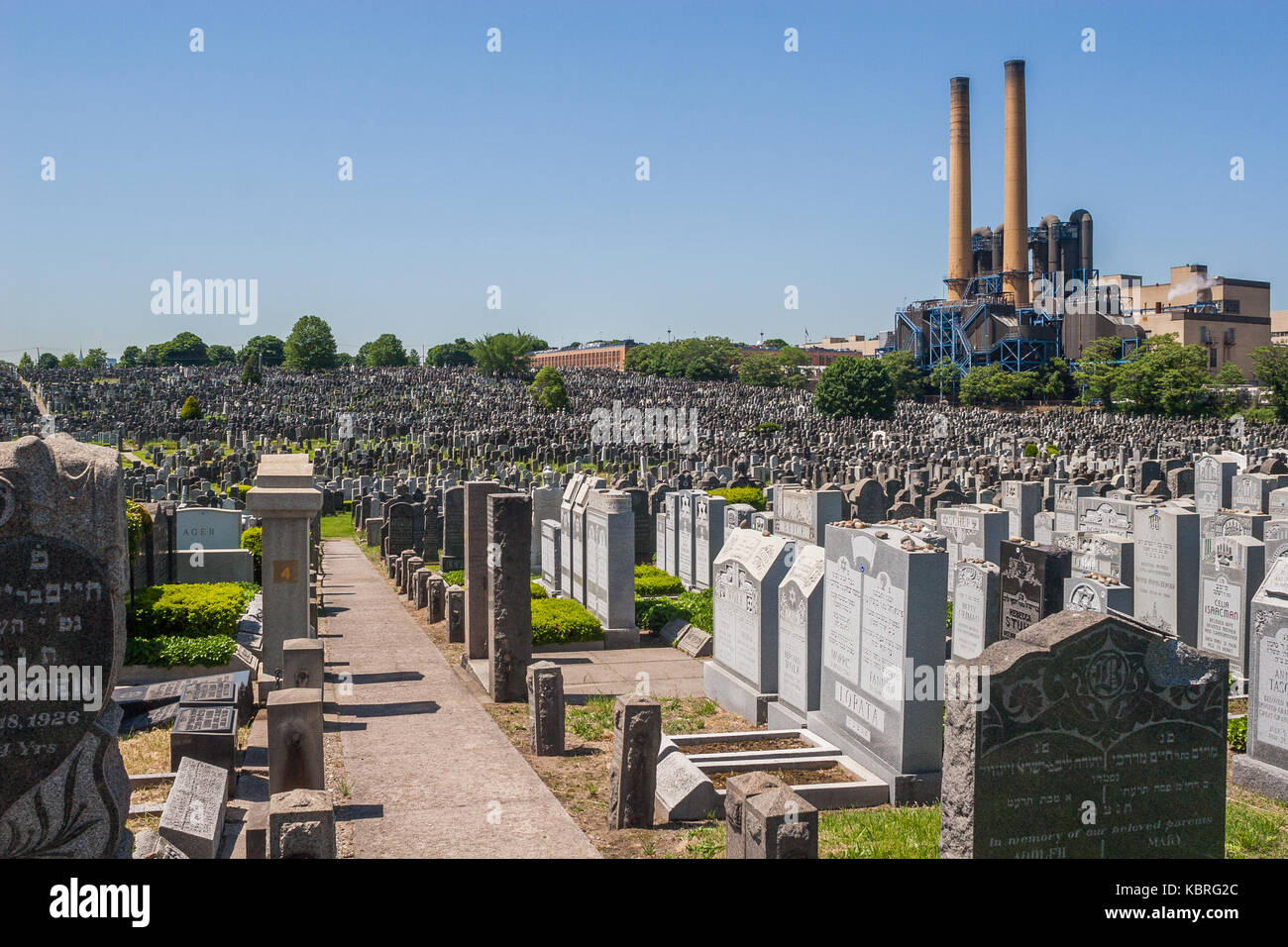 Gravestones at Mount Zion Cemetery in Maspeth, Queens with power plant ...