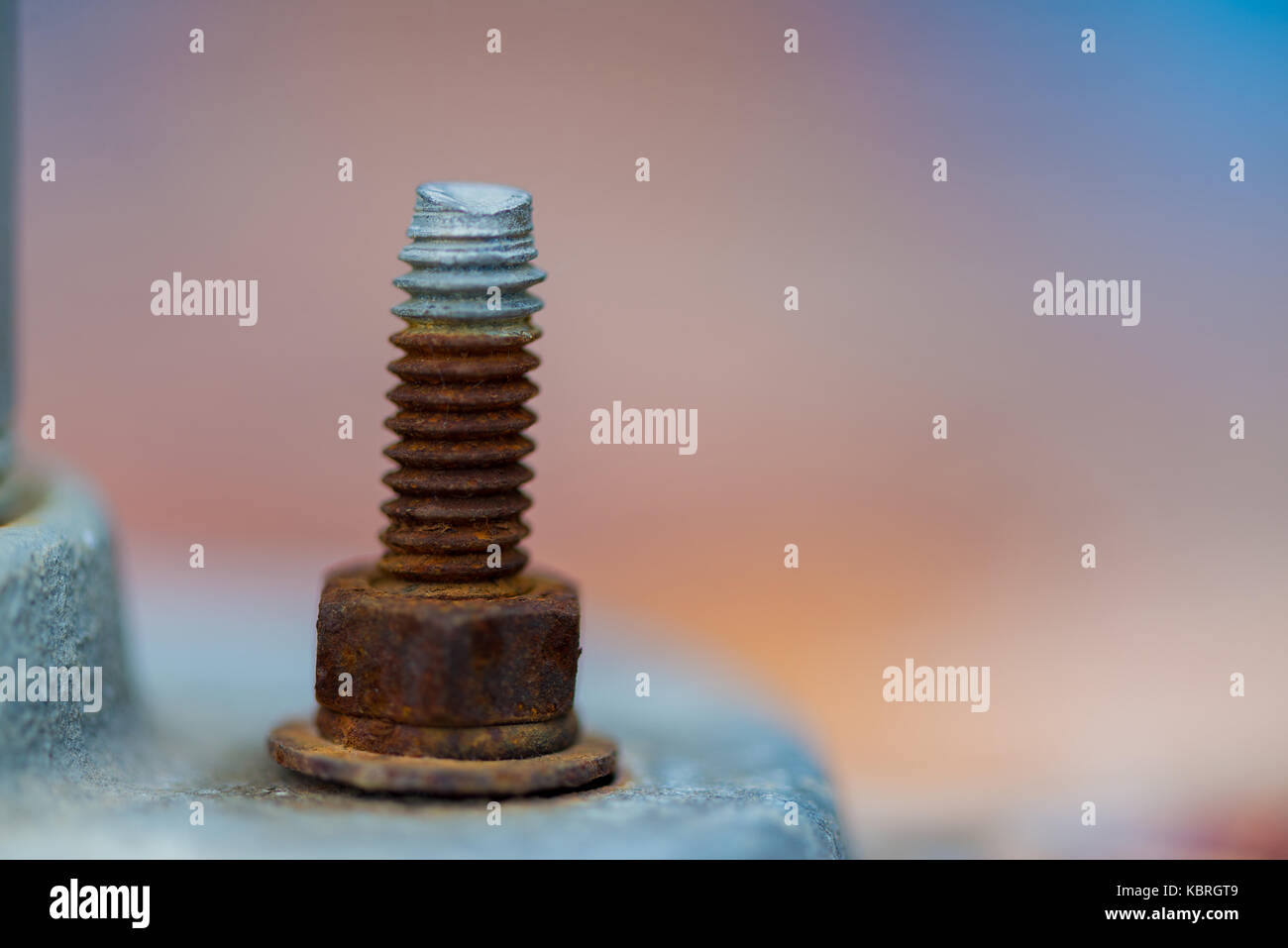 Old rusty steel bolt and nut with flat metal washer, selective focus ...