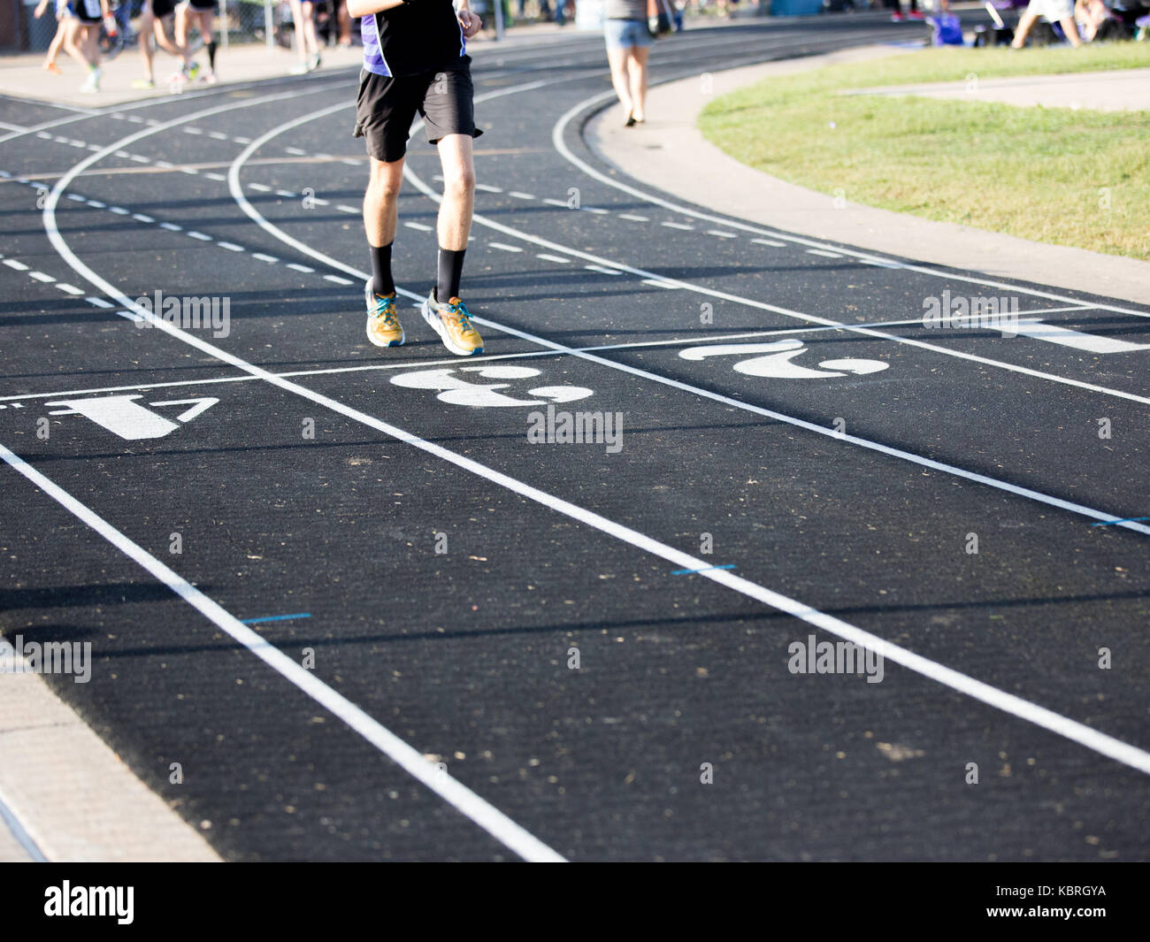 Black Running Surface with white curved lane, lane way Stock Photo - Alamy