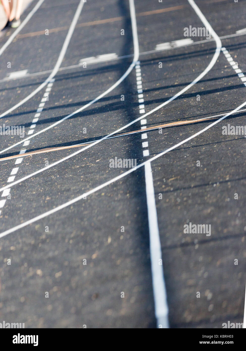 Black Running Surface with white curved lane, lane way Stock Photo - Alamy