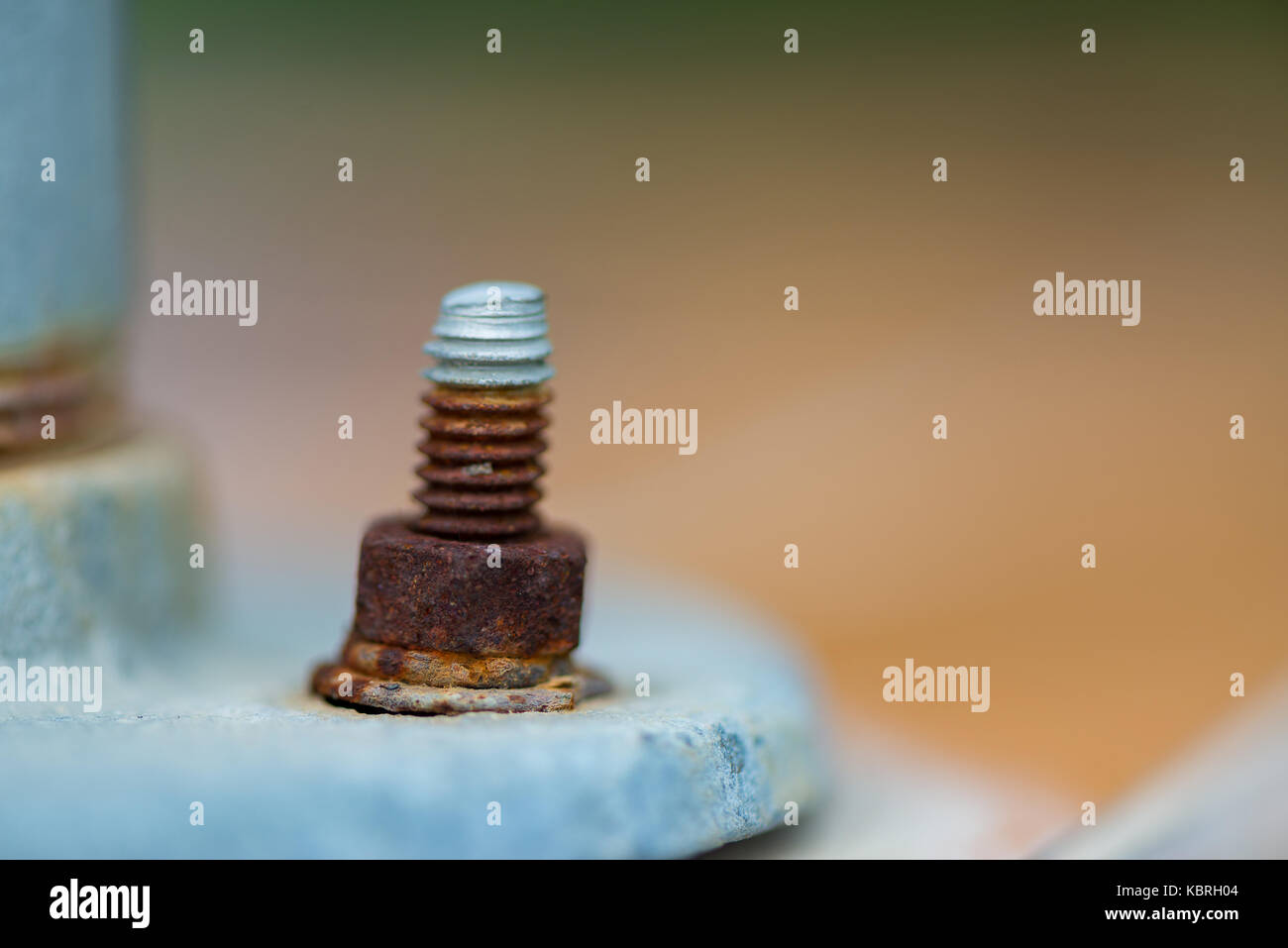 Old rusty steel bolt and nut with flat metal washer, selective focus ...