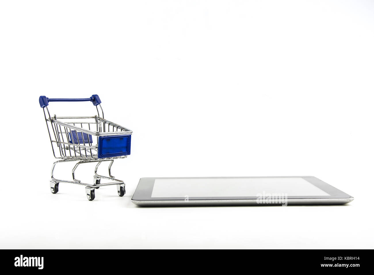 shopping cart with tablet on white backgrond , Means shopping online ...