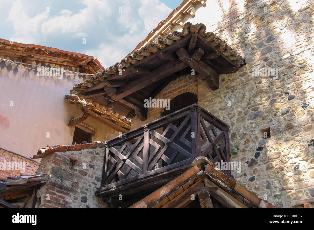 Part of old building with wooden balcony in medieval castle. Grazzano ...