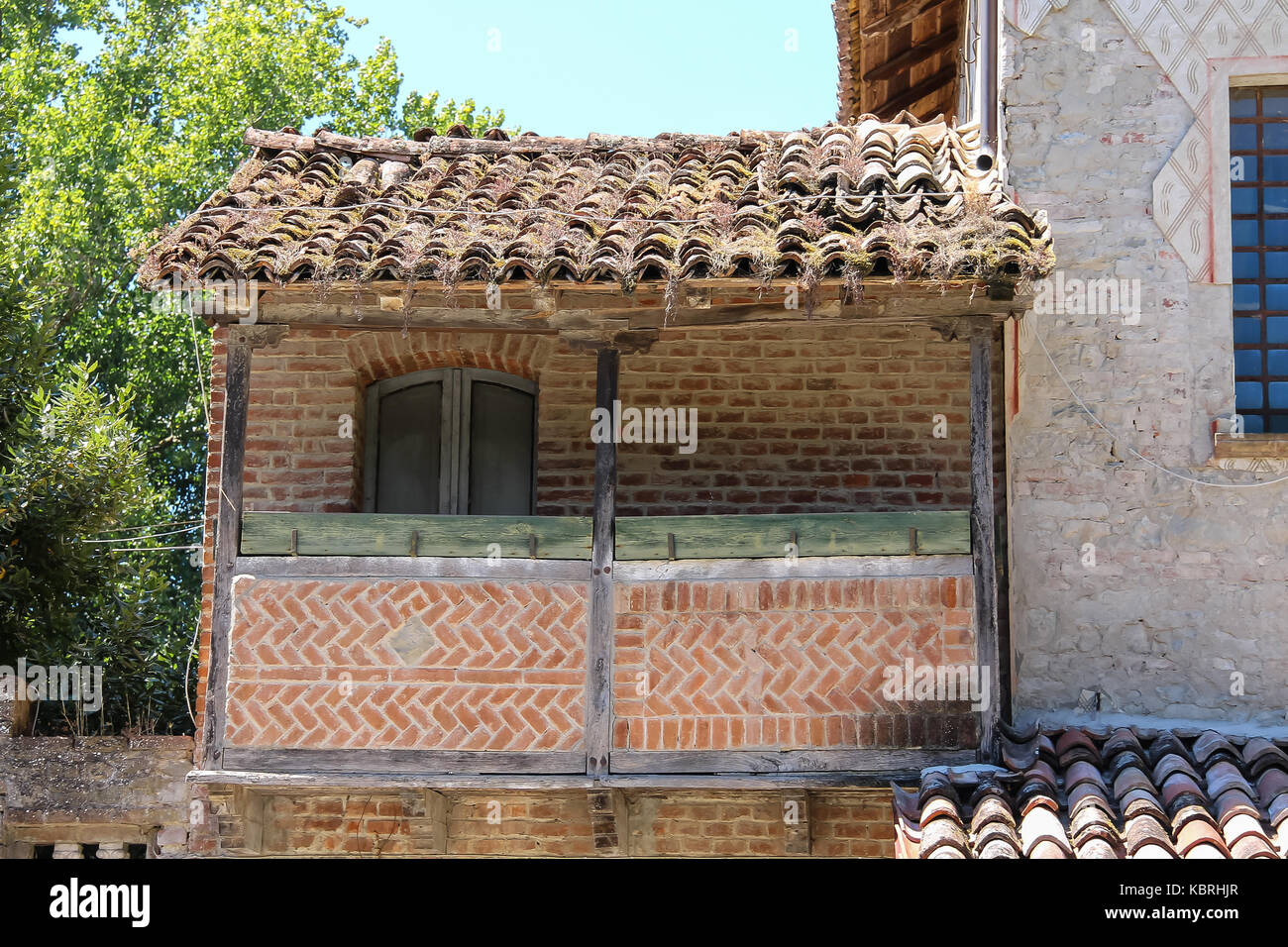 Part of old building with balcony in medieval castle. Grazzano Visconti ...