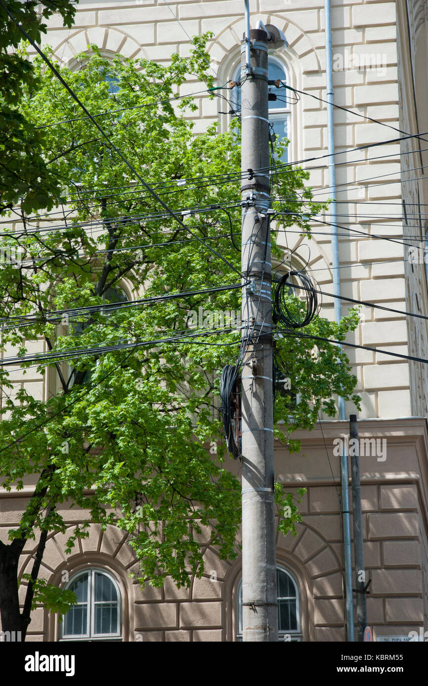 Electric pole with many cables infront of the building Stock Photo - Alamy