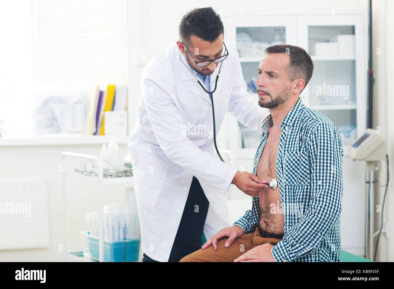 Young physician listening patient using hi-res stock photography and ...