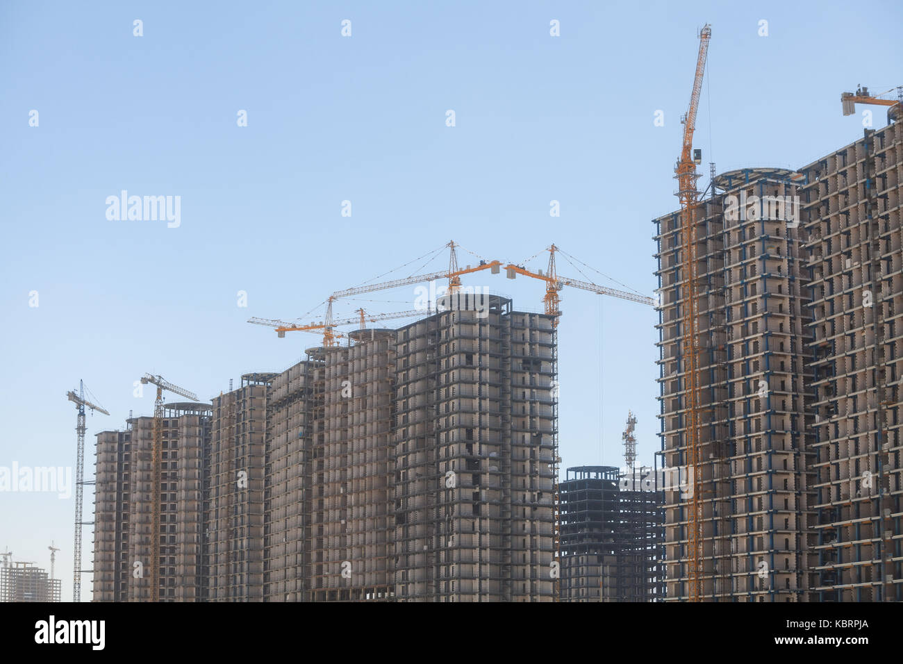 Color image of some cranes building a new structure Stock Photo - Alamy