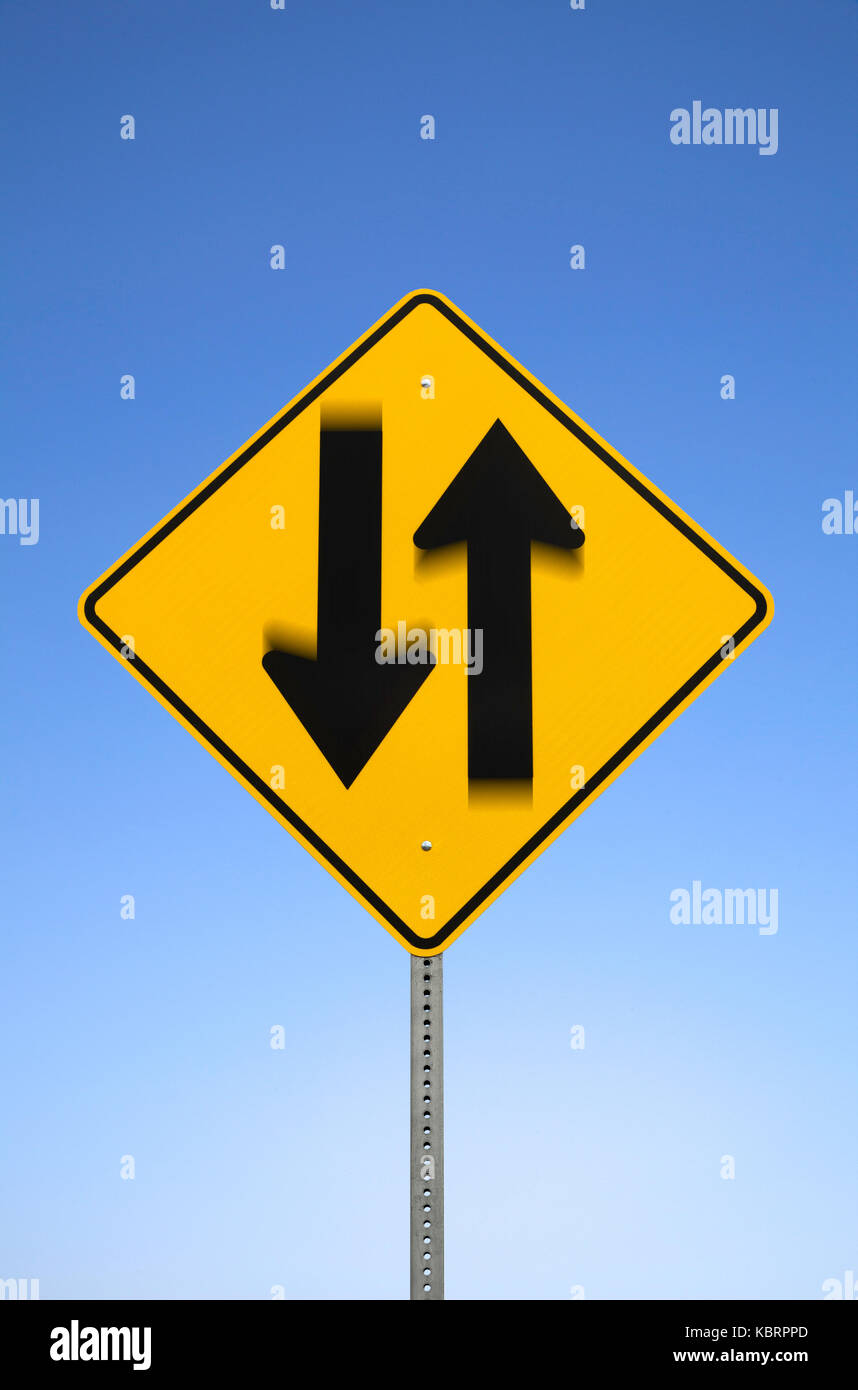Two way roadsign with arrows in motion Stock Photo - Alamy