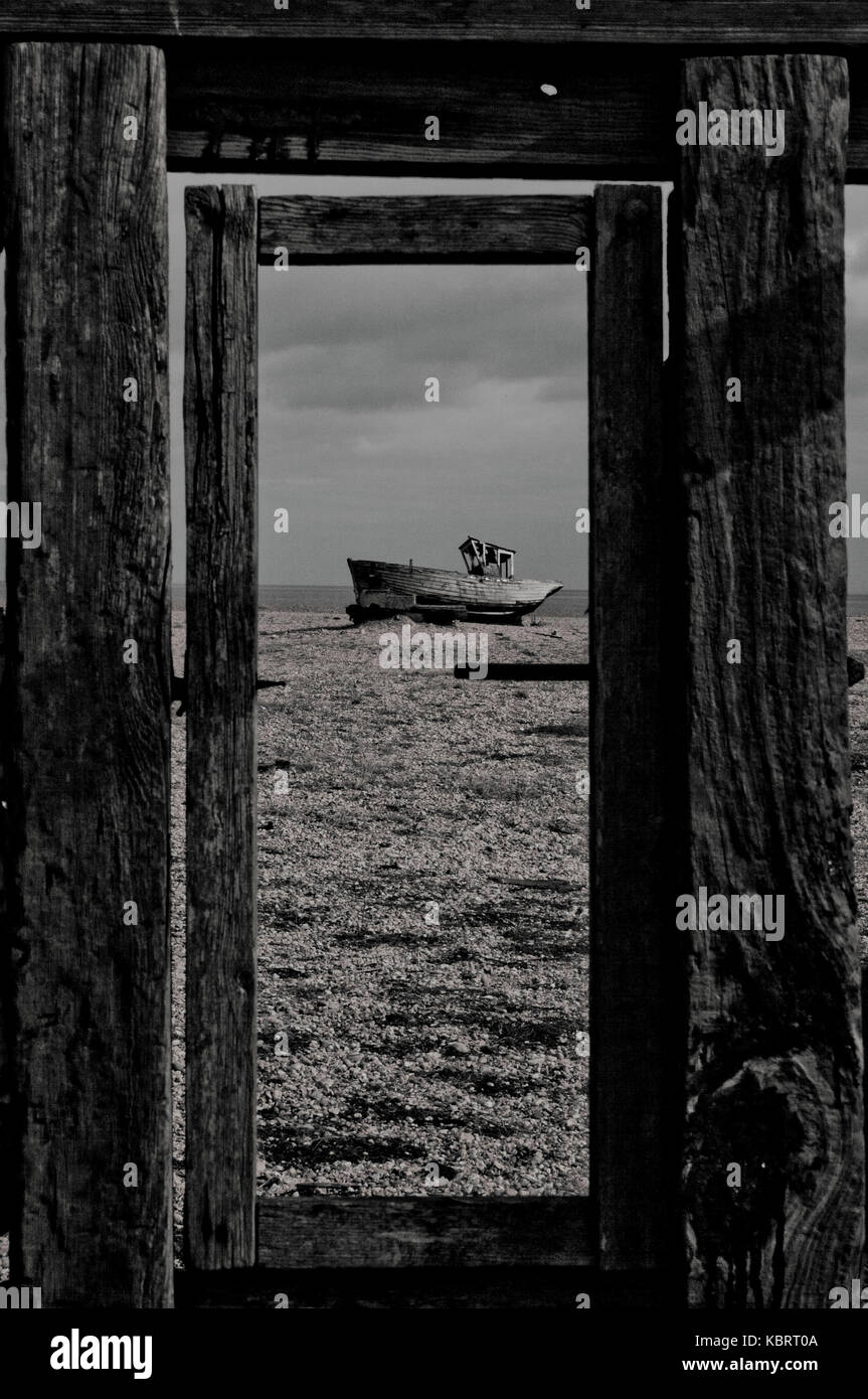 A abandoned boat taken through the window of an abandoned fishing cabin ...