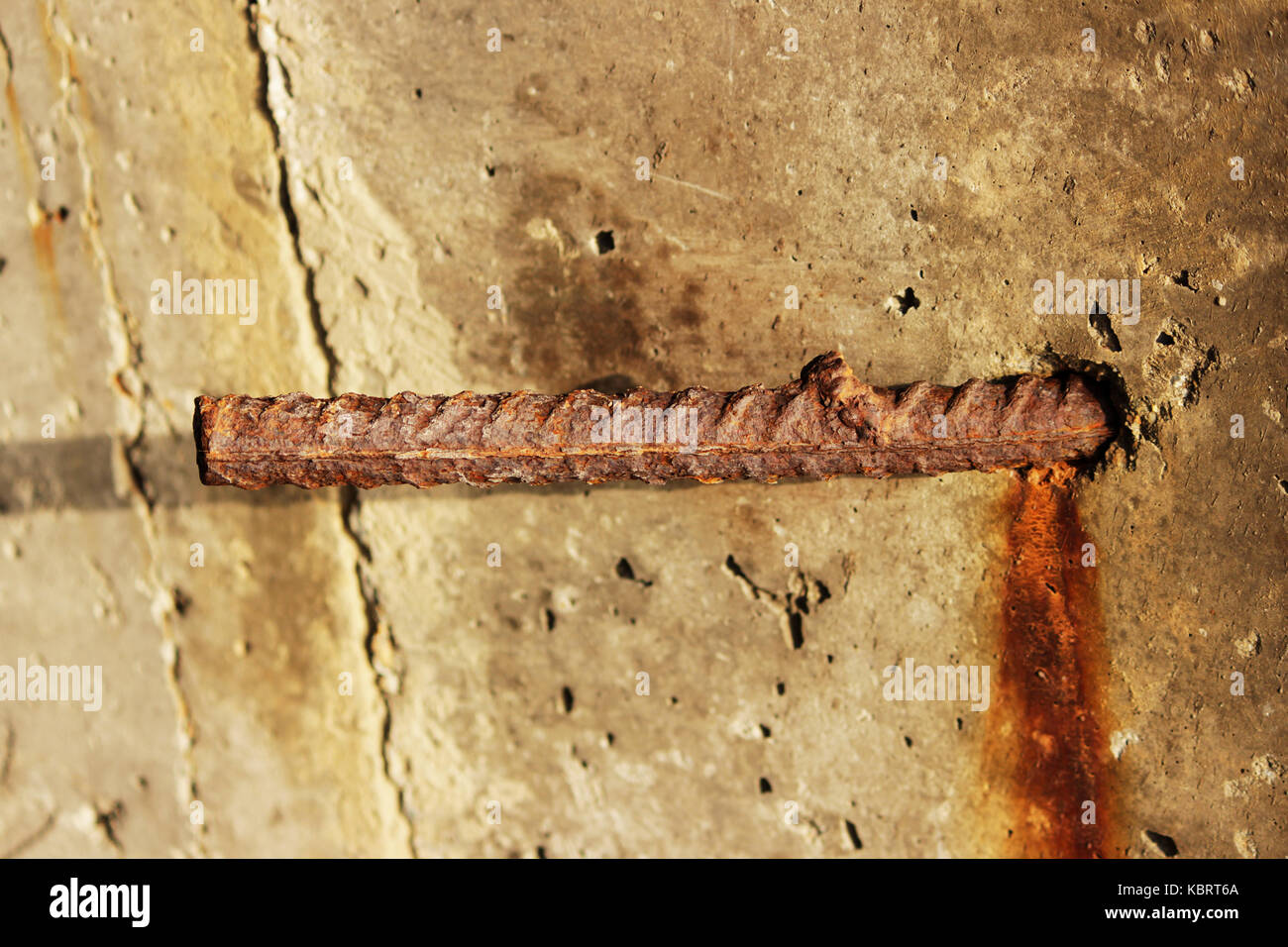 the end of a rusty steel bar sticks out of a concrete slab Stock Photo ...