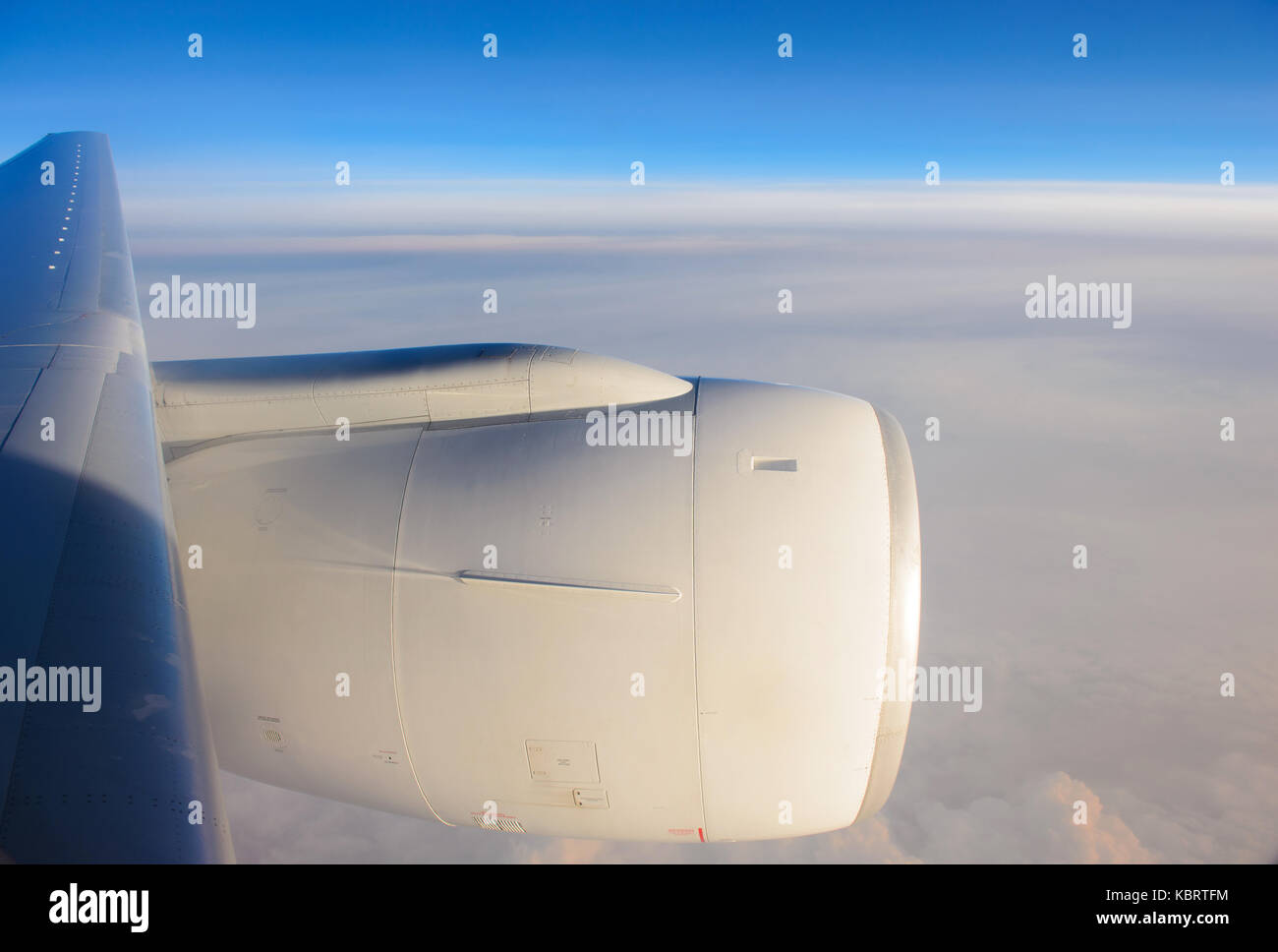 Aircraft window into jet engine with blue sky Stock Photo - Alamy