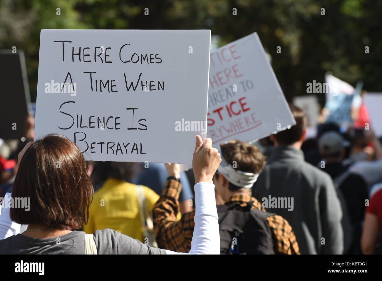 Washington, DC, USA. 30th Sep, 2017. Marchers hold their signs high in ...