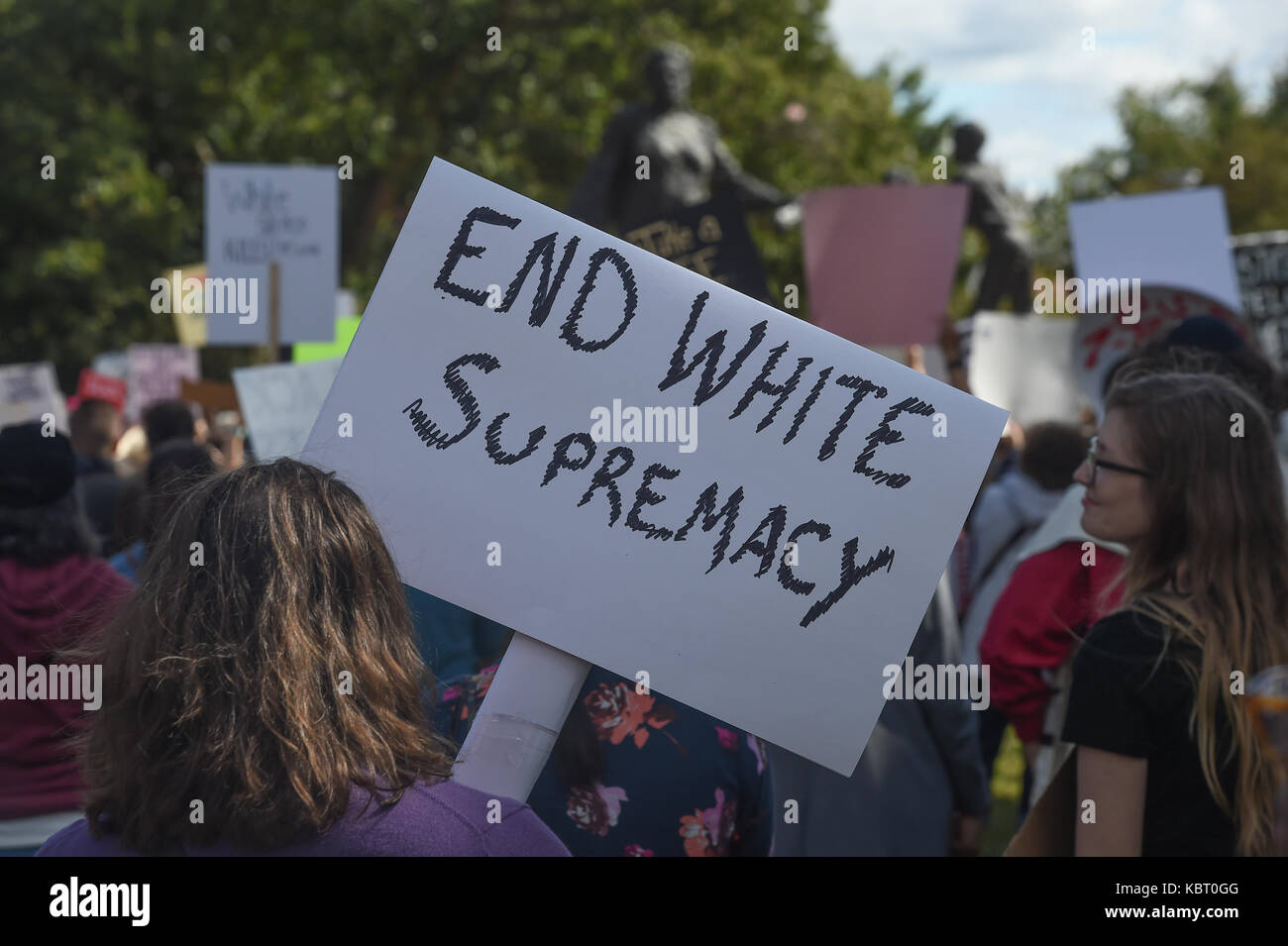 Washington, DC, USA. 30th Sep, 2017. Marchers hold their signs high in ...