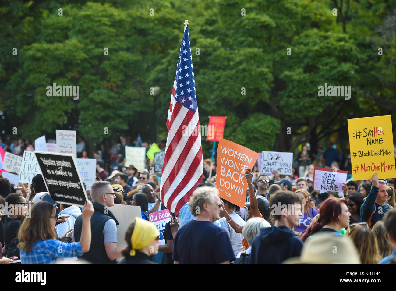 Washington, DC, USA. 30th Sep, 2017. Marchers hold their signs high in ...