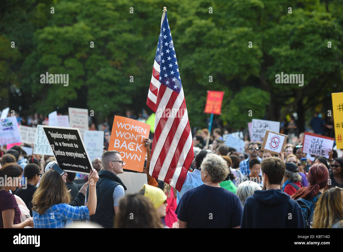 Washington, DC, USA. 30th Sep, 2017. Marchers hold their signs high in ...