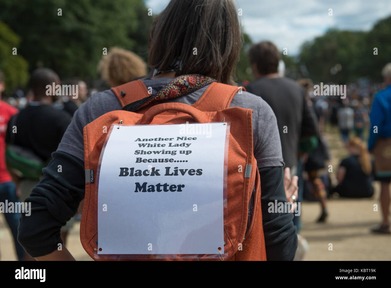 Washington, DC, USA. 30th Sep, 2017. A marcher wears a sign to support ...