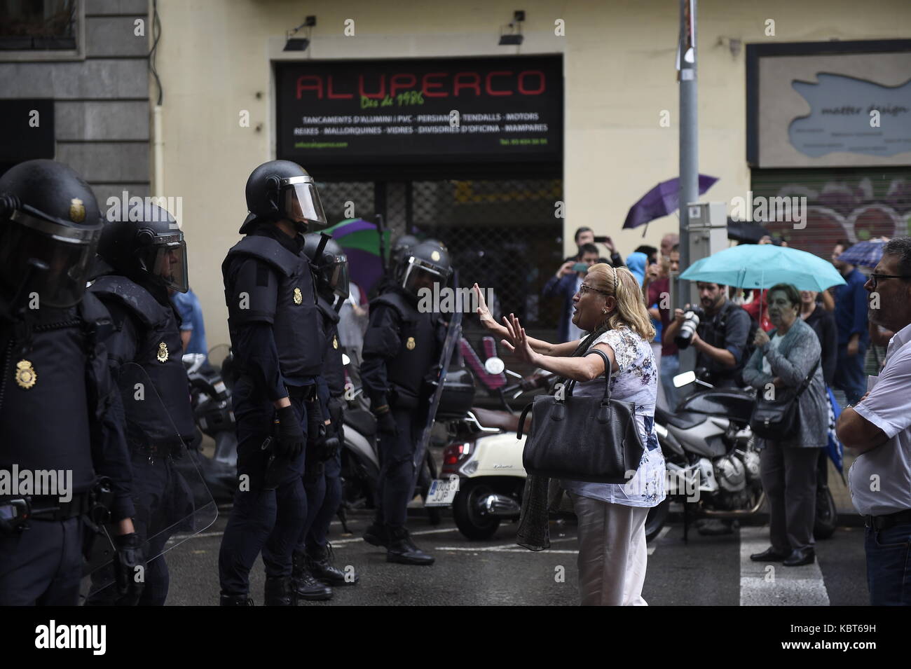 A Spanish National Police officer aims ar rubber-bullet rifle at pro ...