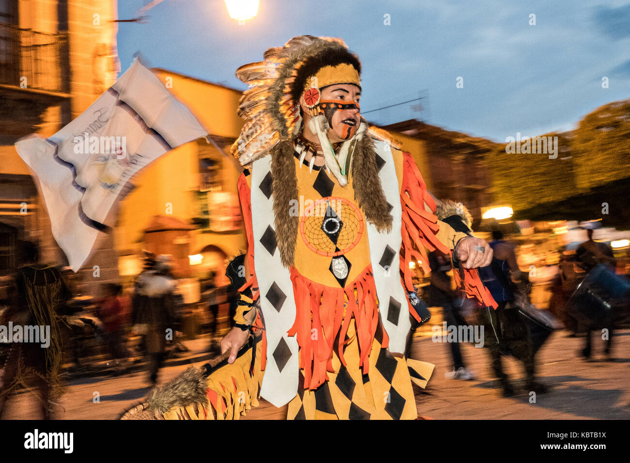 A man dressed in Native American costume performs the Concheros dance ...