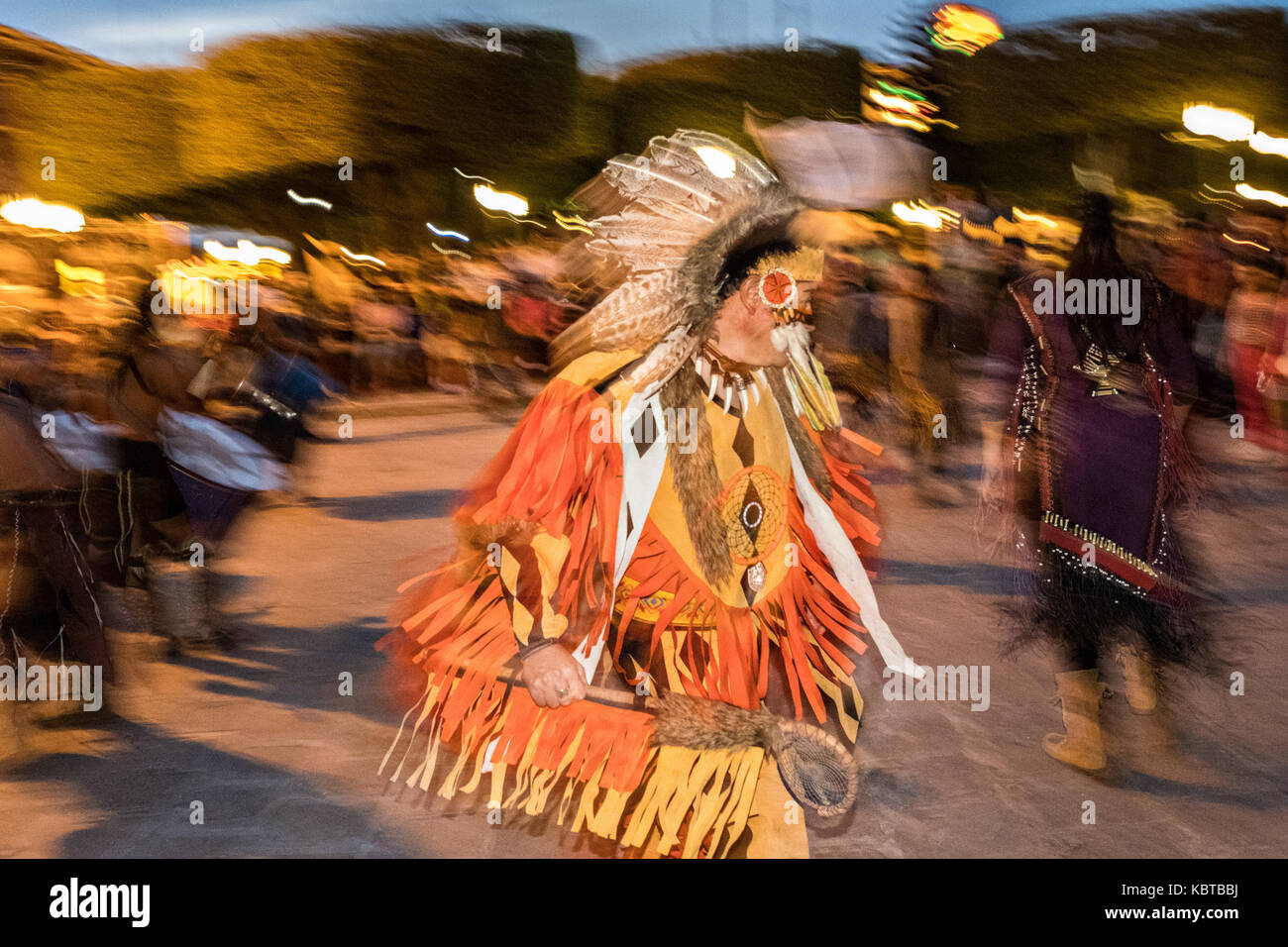 A man dressed in Native American costume performs the Concheros dance ...