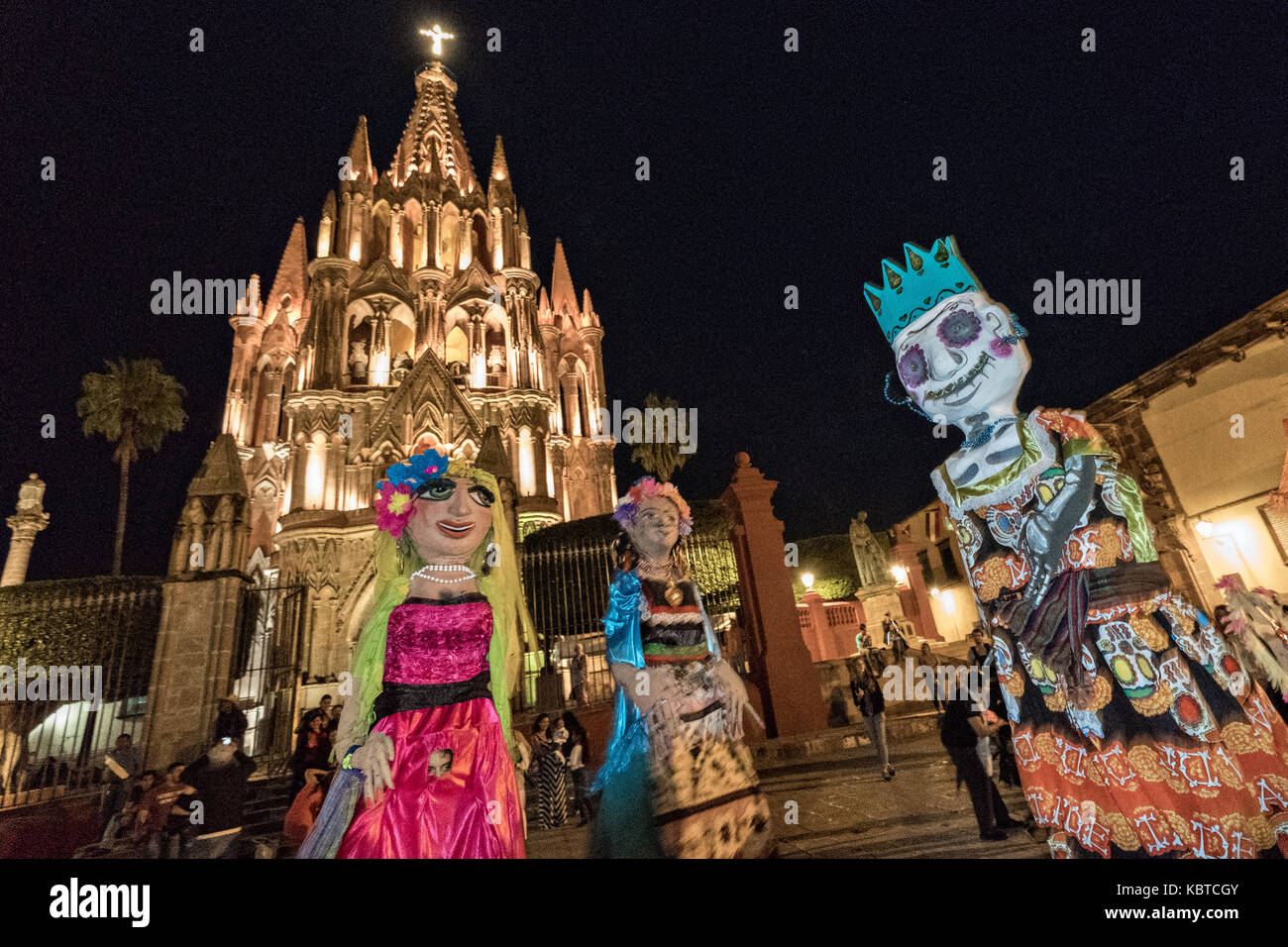 Giant paper-mache puppets called mojigangas dance past the Parroquia ...