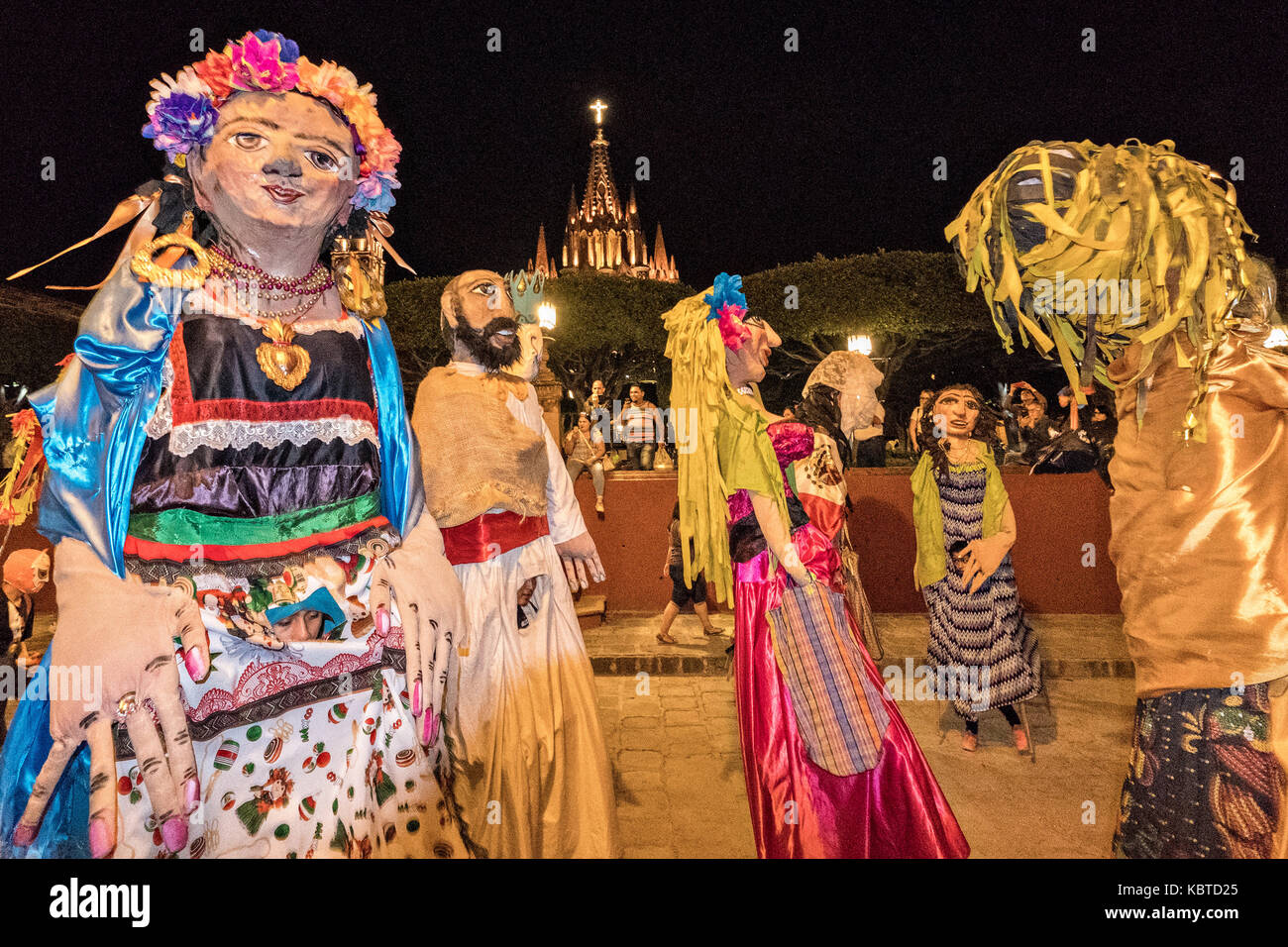 Giant paper-mache puppets called mojigangas dance past the Parroquia ...