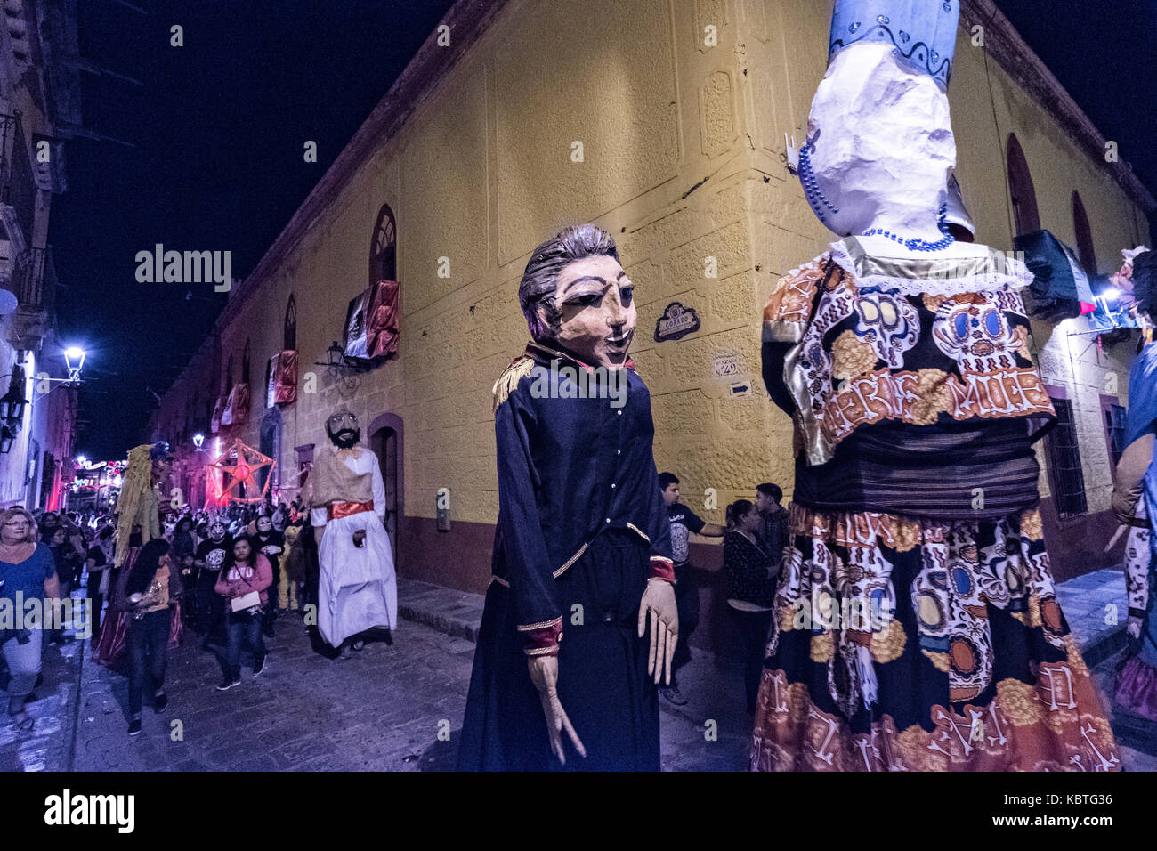 Giant paper-mache puppets called mojigangas lead a procession through ...