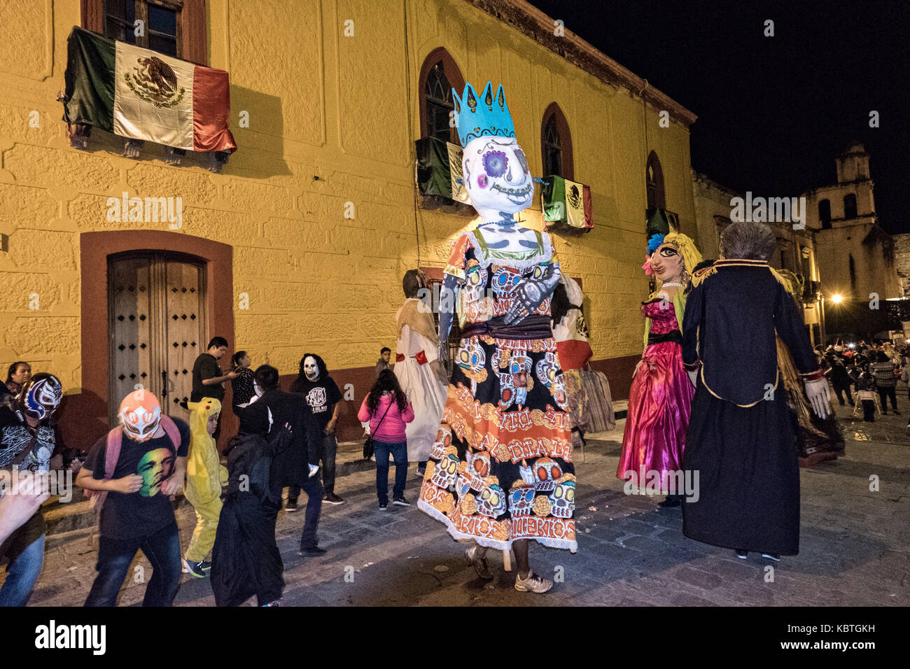 Giant paper-mache puppets called mojigangas lead a procession through ...