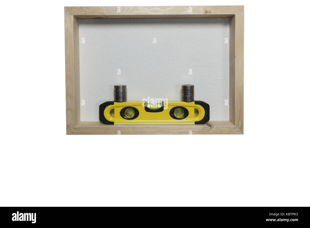 Yellow building level, balance ruler with stack coins in wooden frame ...