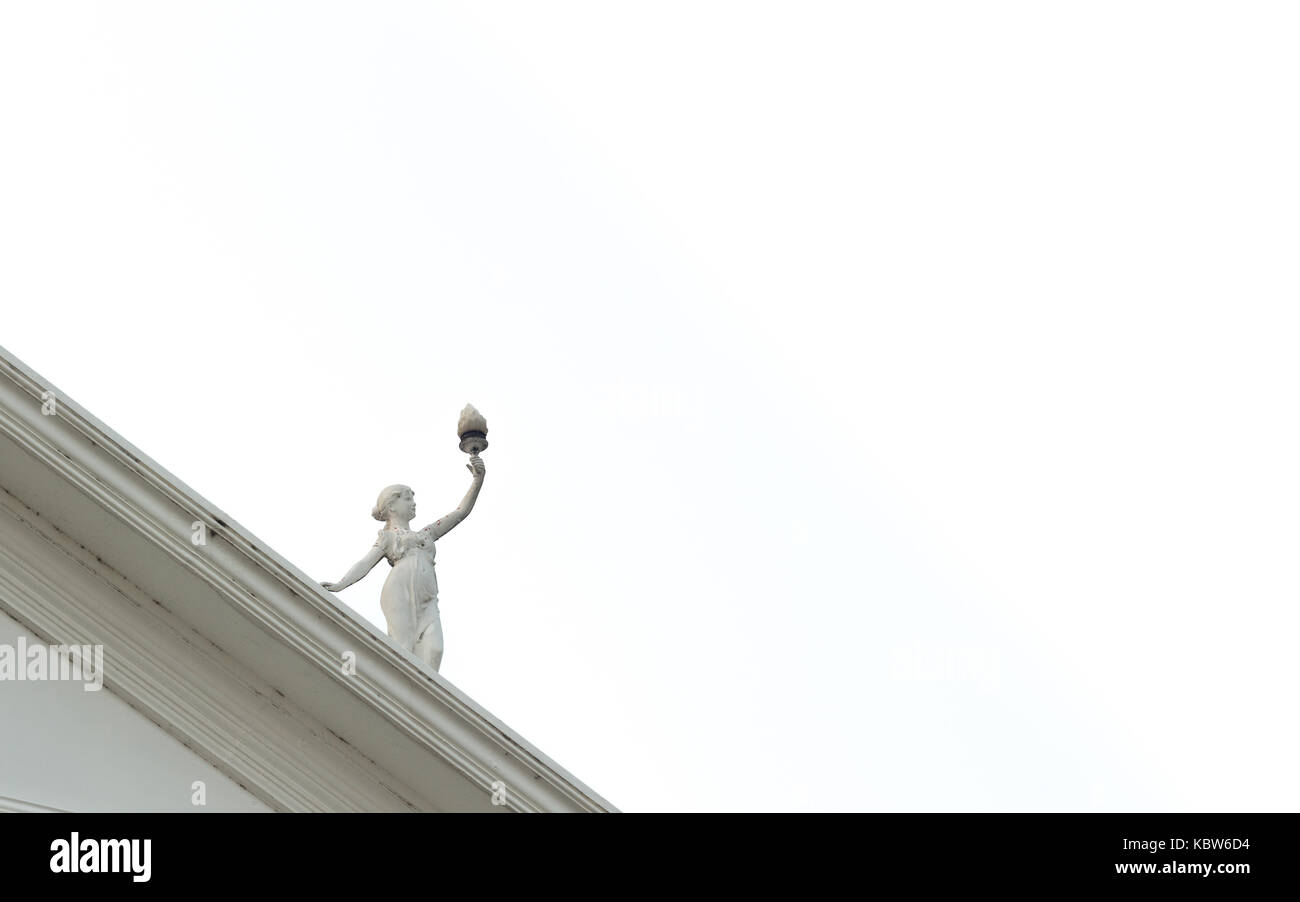 Statue of a beautiful child that hold the flame torch and isolated on ...