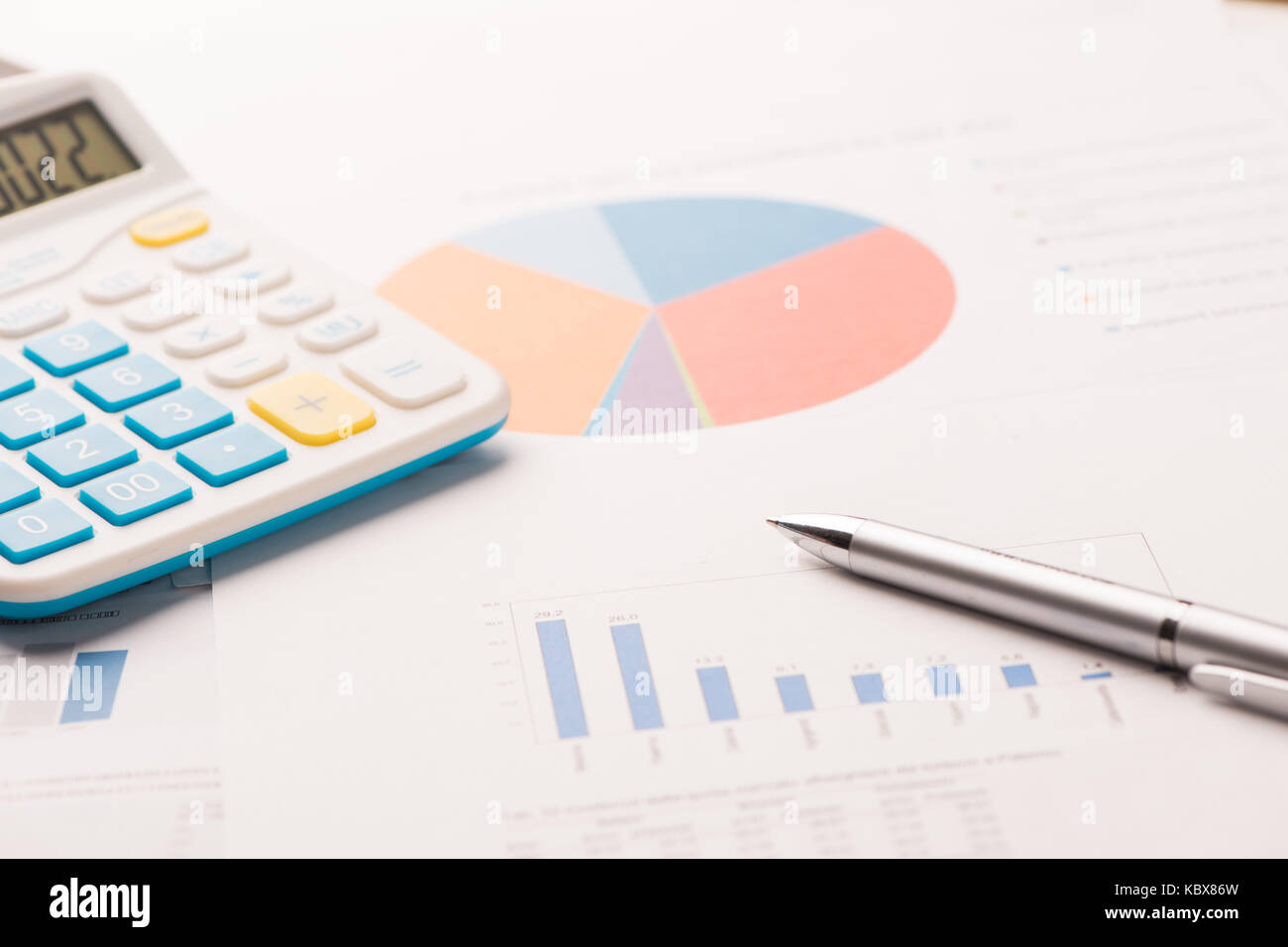 Financial statements. Business Graph. Focus on pen. Shallow depth of ...