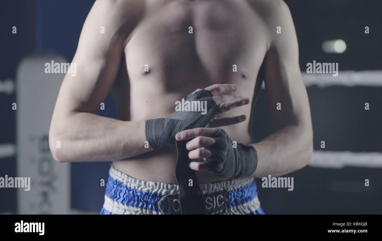 Closeup of a mixed martial arts fighter wrapping his hands before a ...