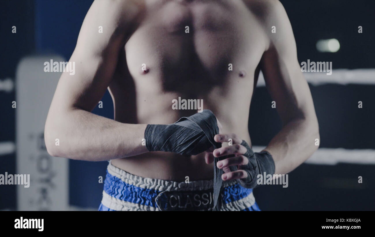 Closeup of a mixed martial arts fighter wrapping his hands before a ...