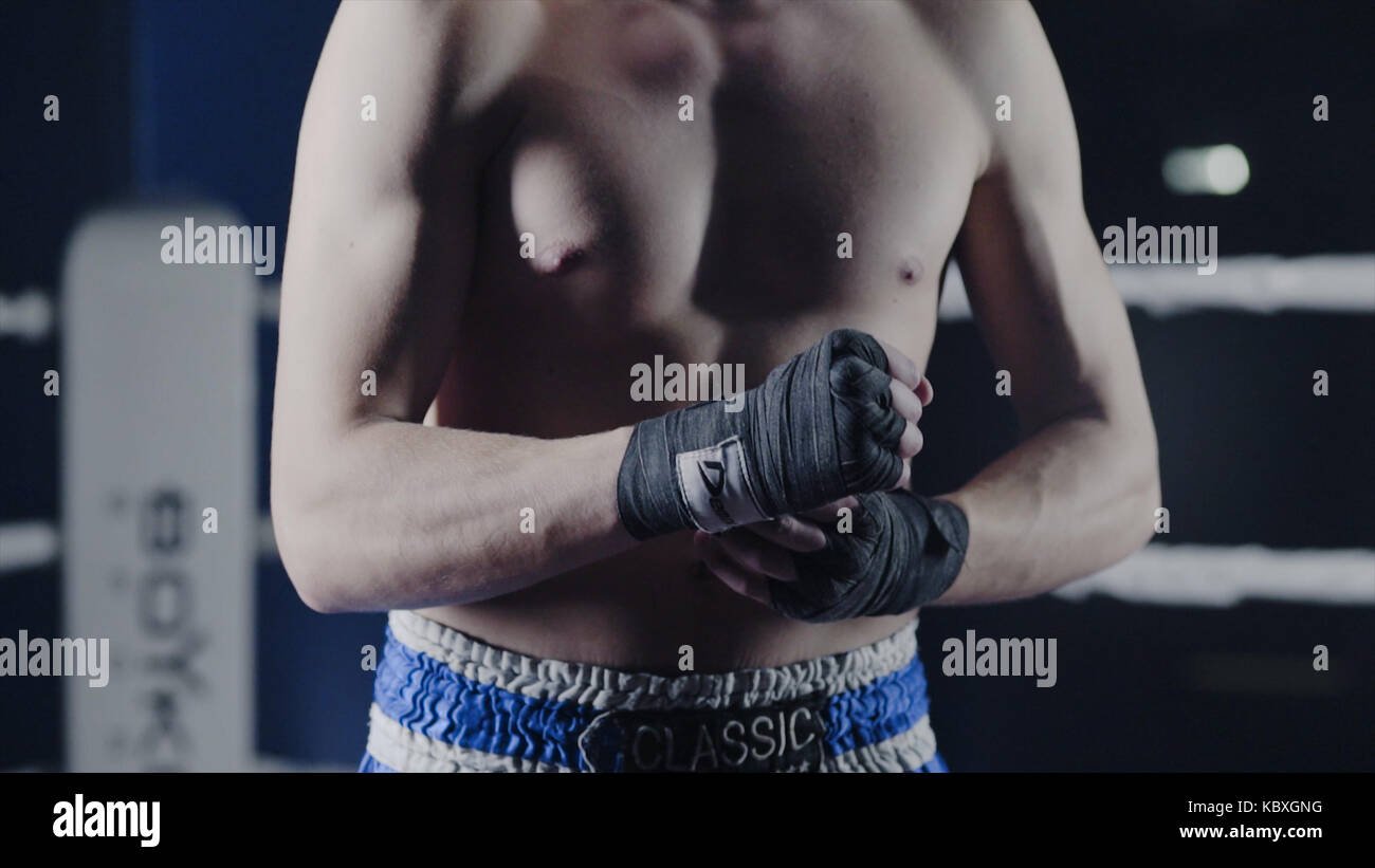 Closeup of a mixed martial arts fighter wrapping his hands before a ...