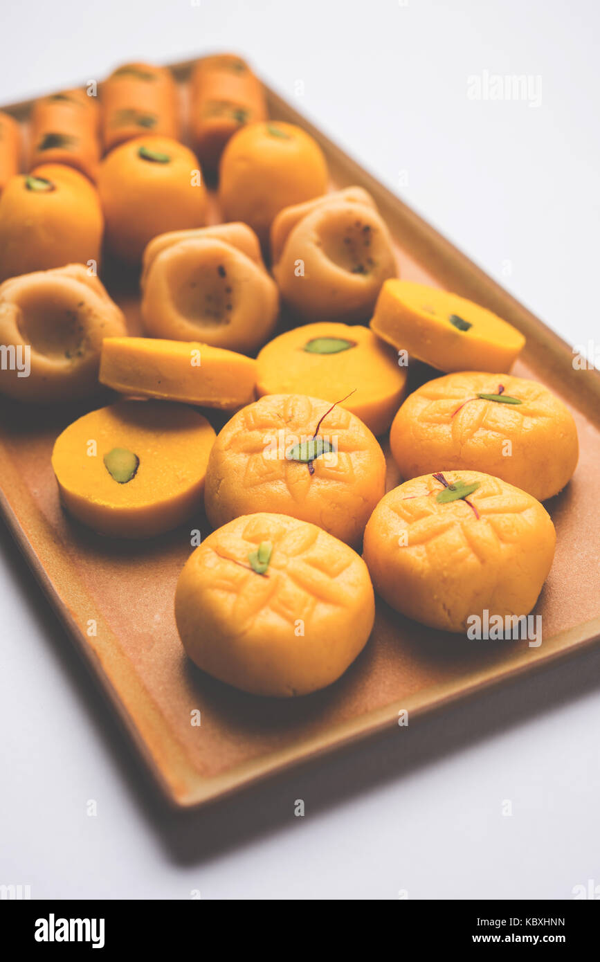 stock photo of collection of variety of sweets or orange peda or pedha ...
