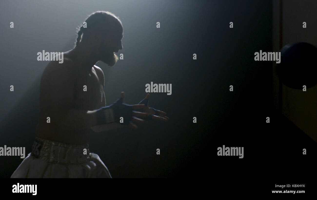 Fit man throwing medicine ball doing ball slam against gym floor or ...
