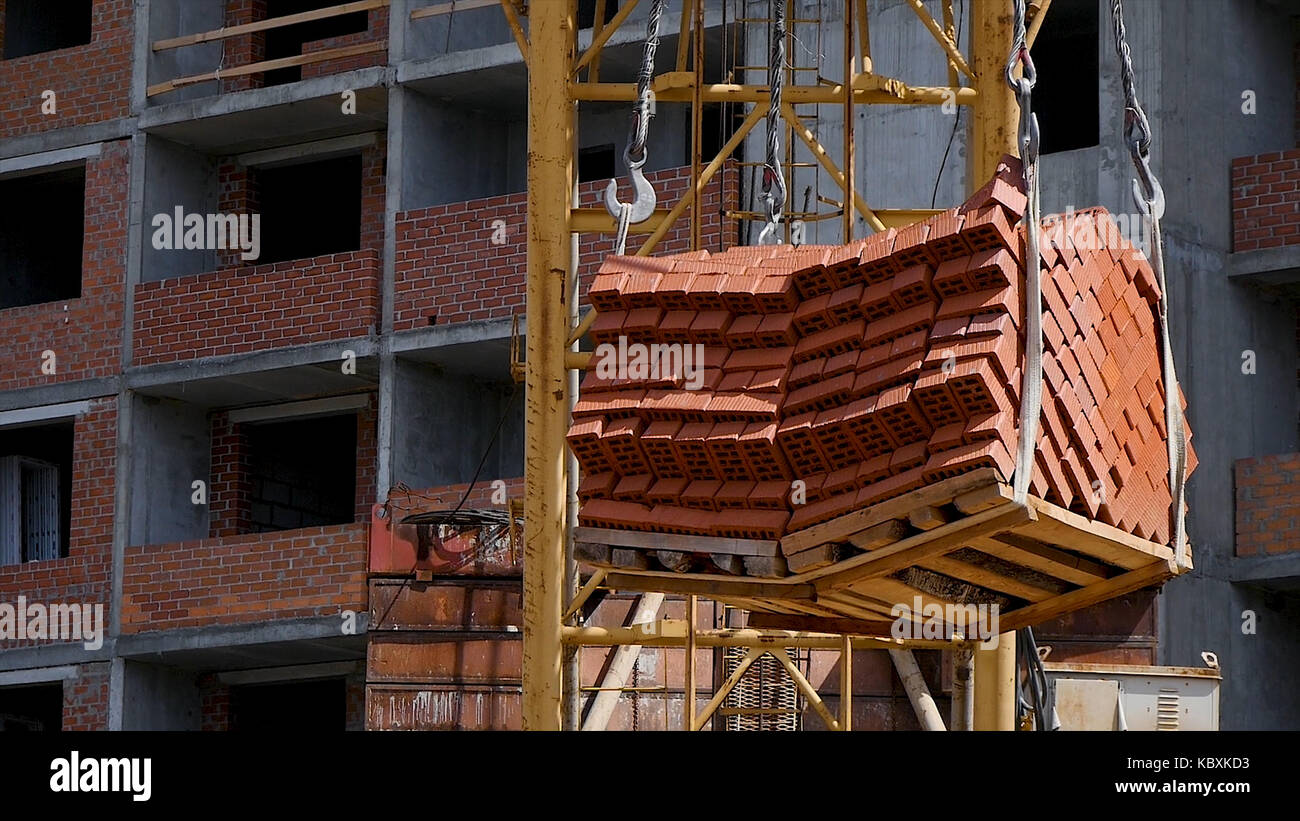 Crane and building construction site against blue sky. heavy load ...