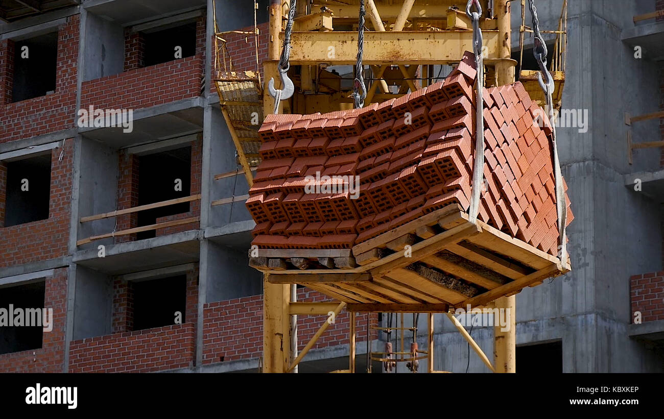Crane and building construction site against blue sky. heavy load ...
