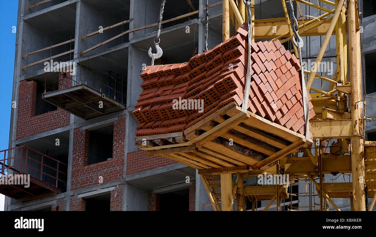 Crane and building construction site against blue sky. heavy load ...