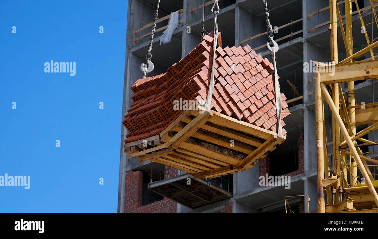 Crane and building construction site against blue sky. heavy load ...