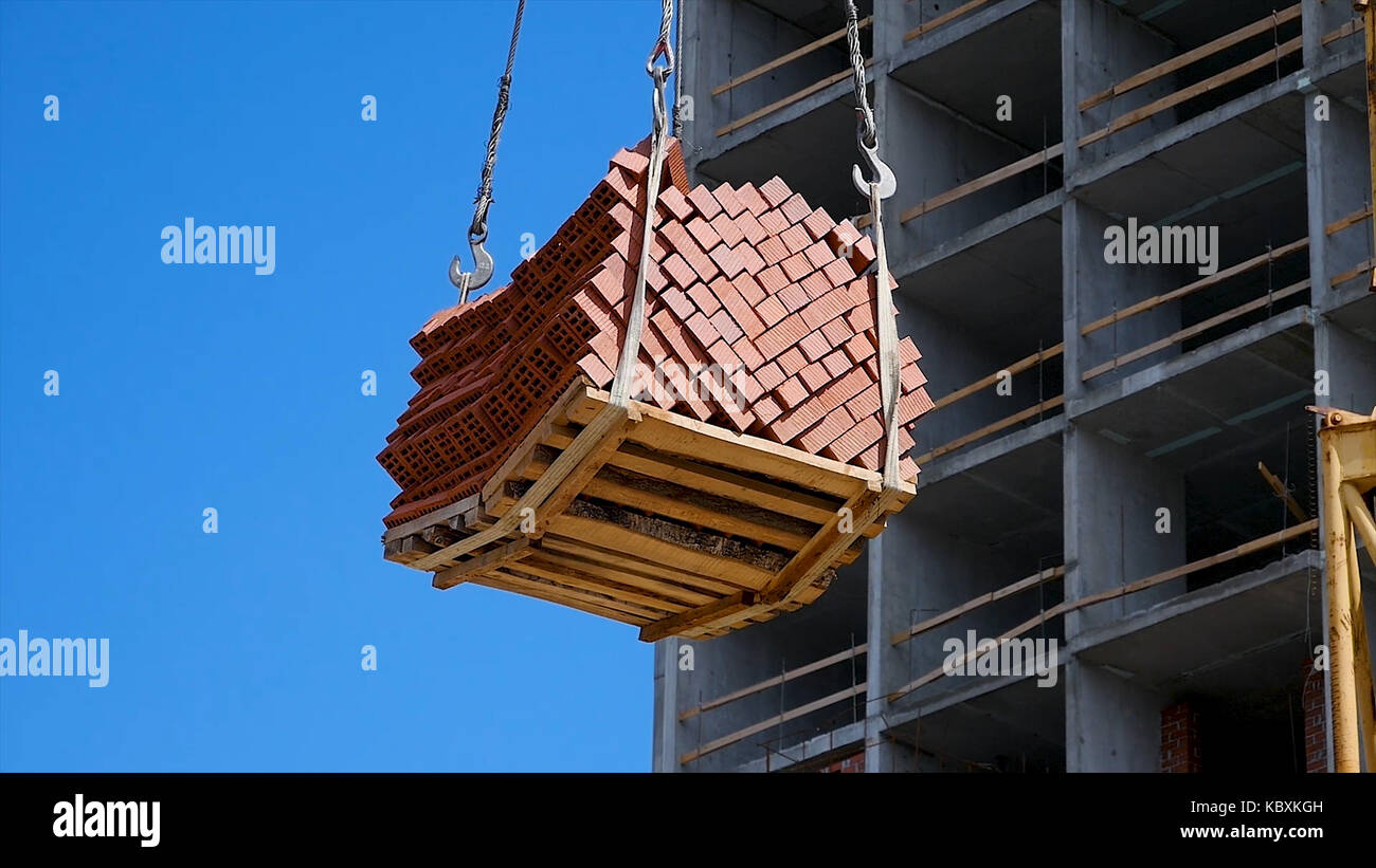 Crane and building construction site against blue sky. heavy load ...