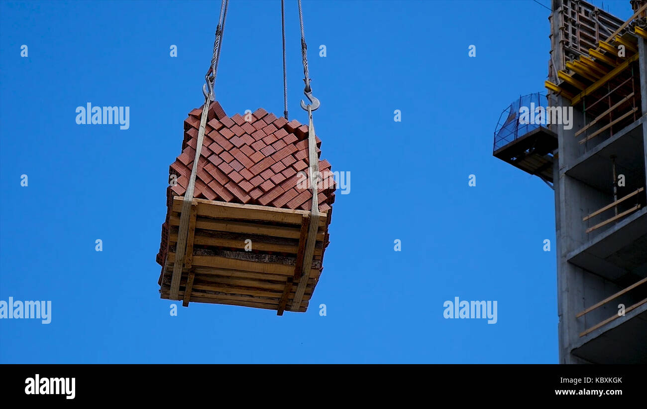 Crane and building construction site against blue sky. heavy load ...
