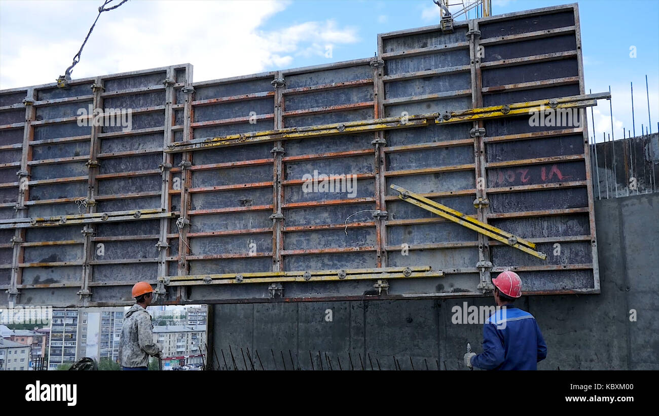 Construction of a modern building and a skyscraper. construction worker ...