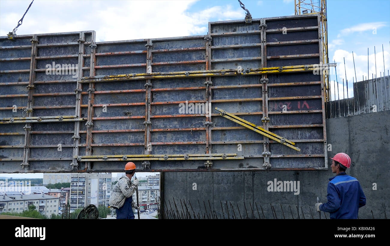 Construction of a modern building and a skyscraper. construction worker ...