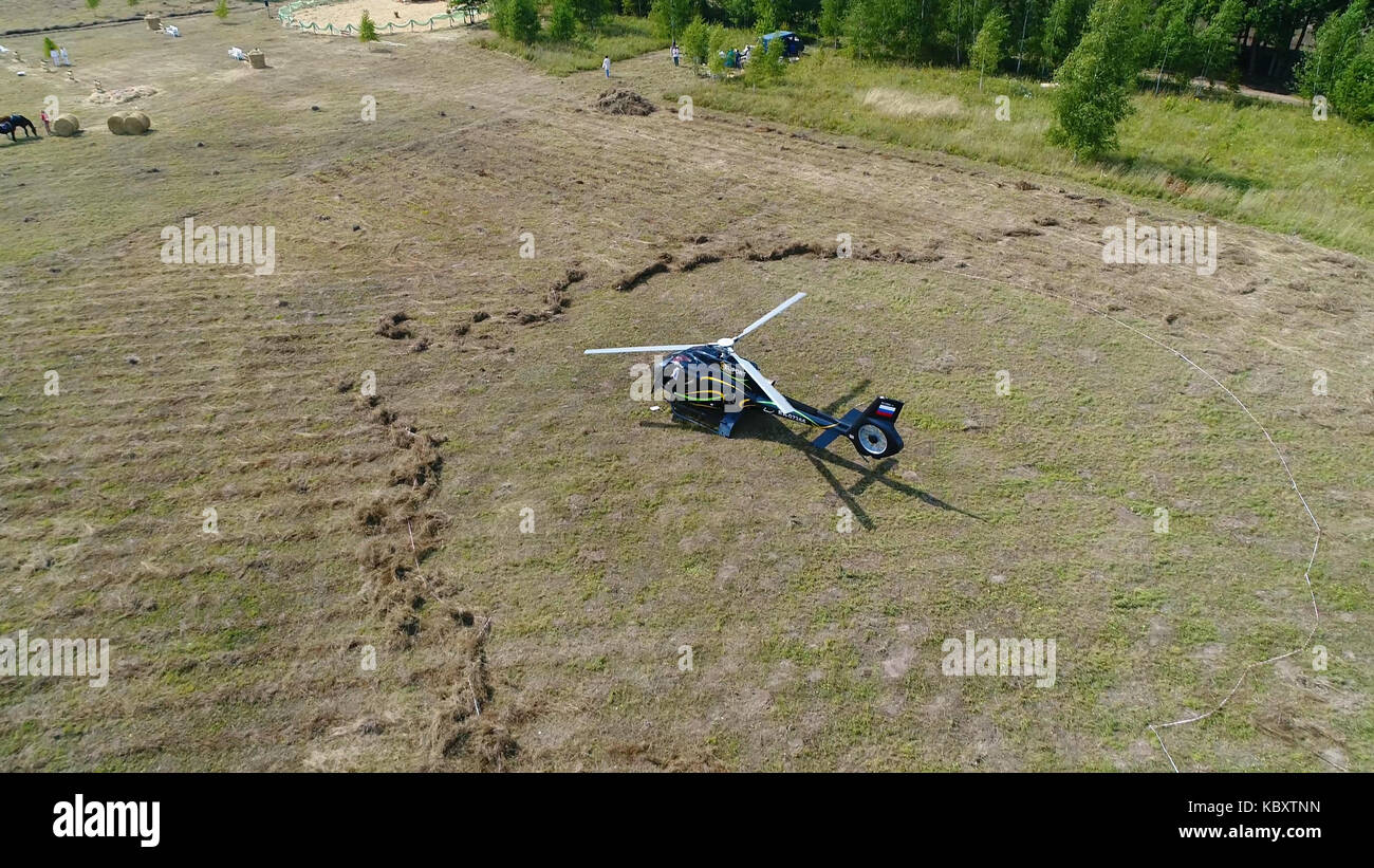 Helicopter hovering over field. Helicopter landed on the field near the ...