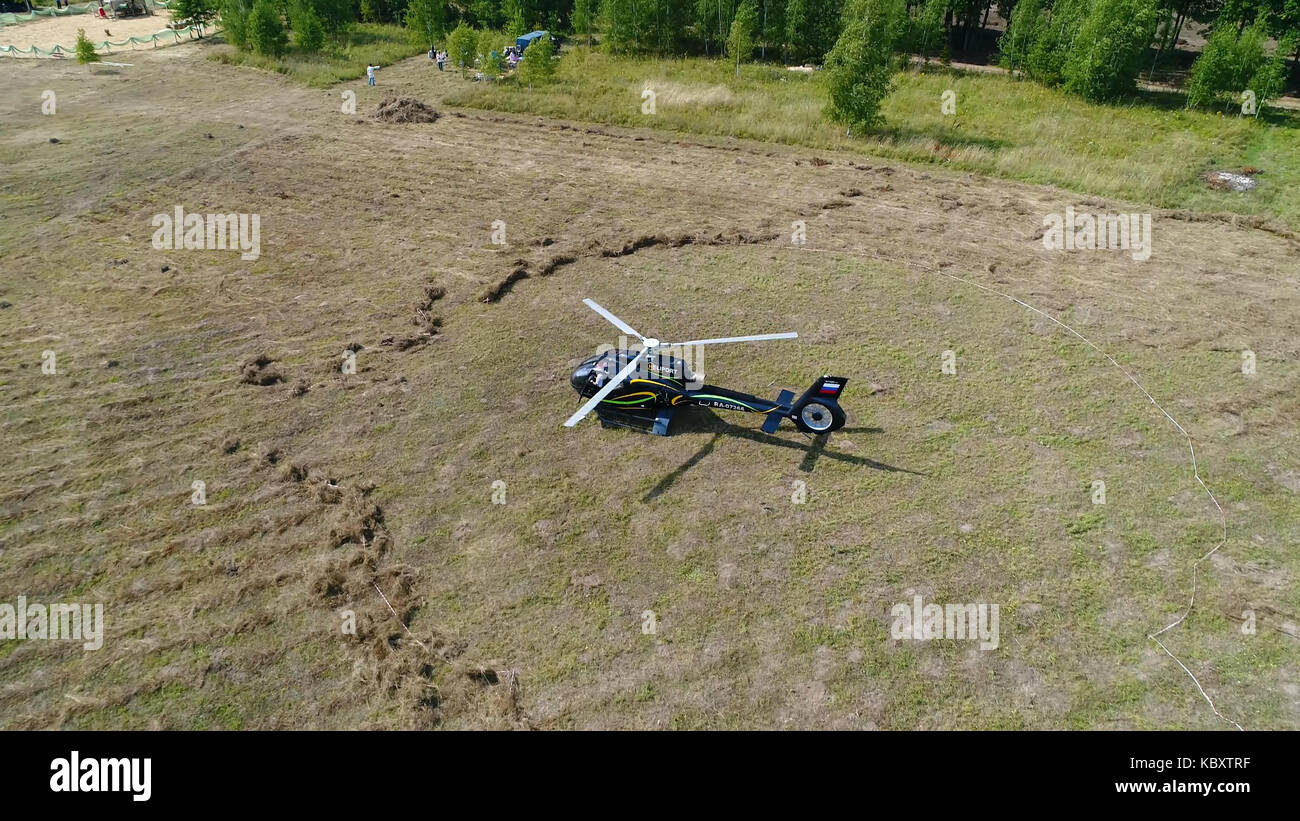 Helicopter hovering over field. Helicopter landed on the field near the ...