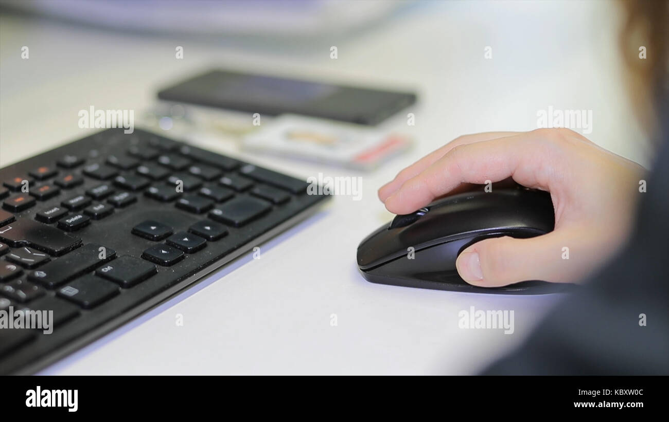 Closeup of woman hand clicking mouse outdoor. Closeup of female fingers ...