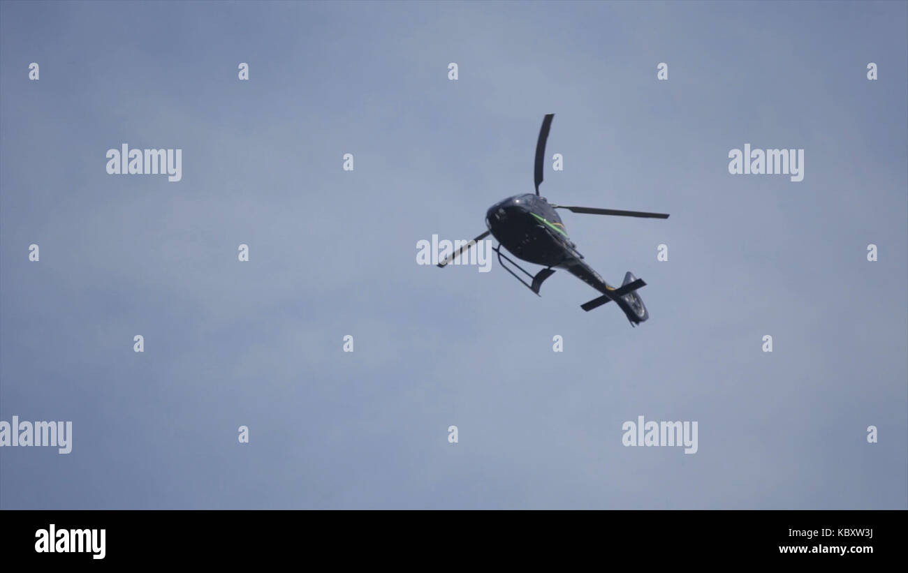 helicopter in the cloudy sky with lightning. Helicopter From Below ...