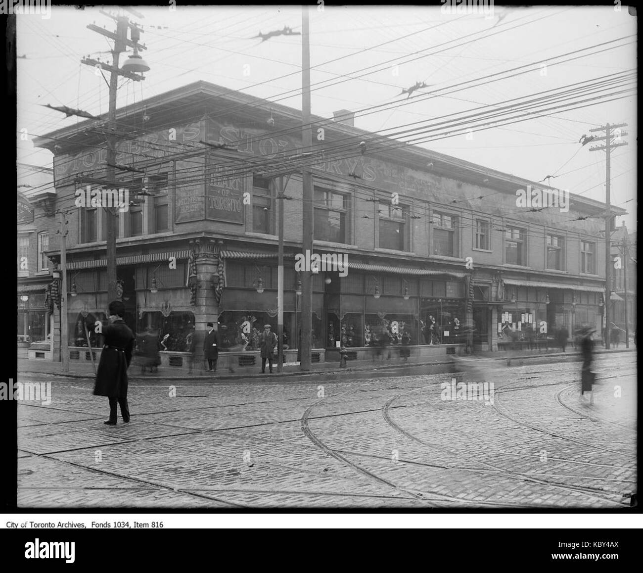 A historic photograph of a policeman wearing a fur busby, directing ...