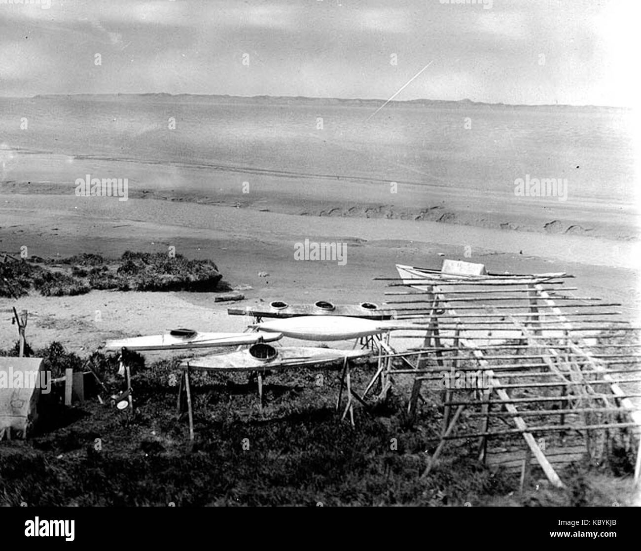 Eskimo bidarkas (skin covered boats)on the beach at Egegik, Alaska, ca ...