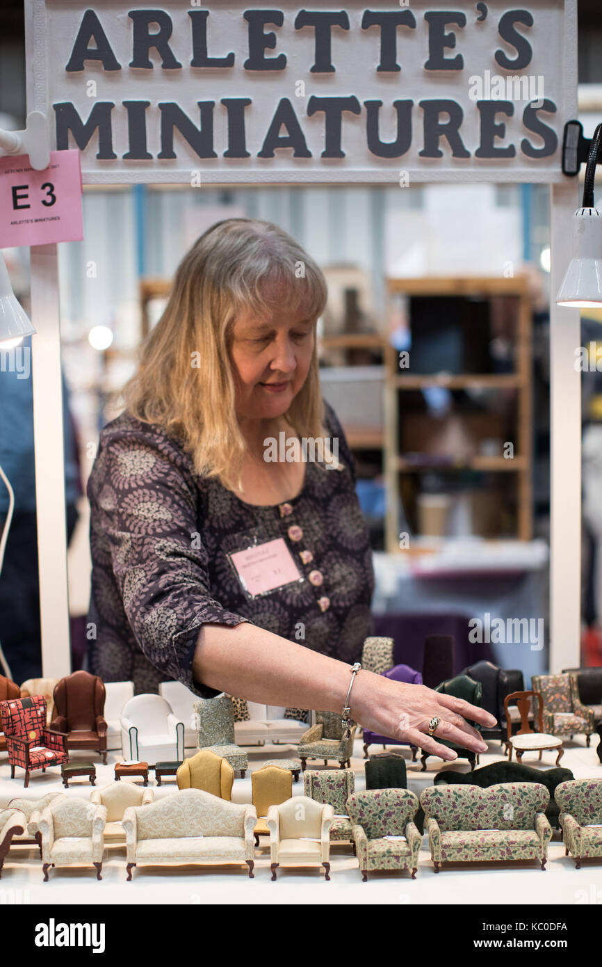 Visitors look at miniature furniture on display at the Miniatura ...